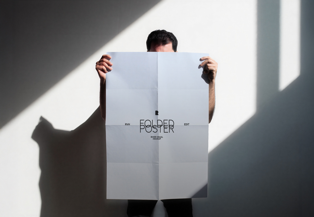 Holding Poster with Folds Mockup - Mockup World