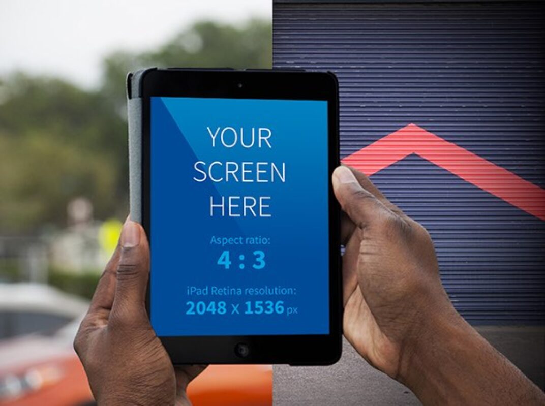 Hands holding iPad outside Mockup - Mockup World