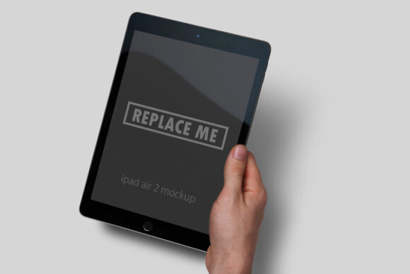 Black iPad in Hand Mockup - Mockup World