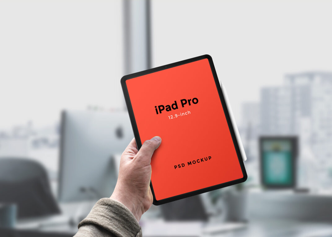 Hand holding iPad Pro Mockup - Mockup World