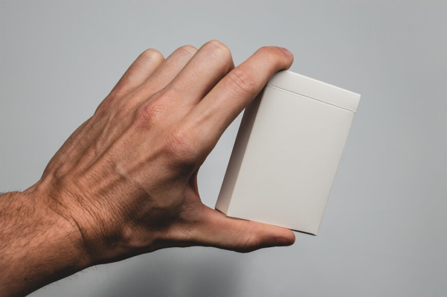 Hand holding Playing Cards Box Mockup - Mockup World