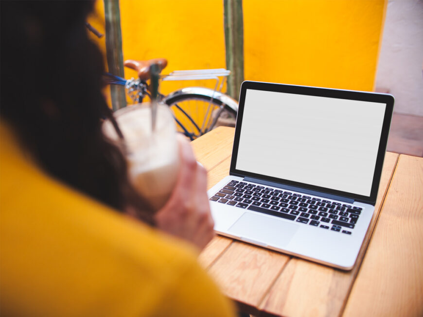 Woman working on MacBook Mockup Generator - Mockup World