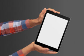 Hand holding iPad Mini Mockup - Mockup World