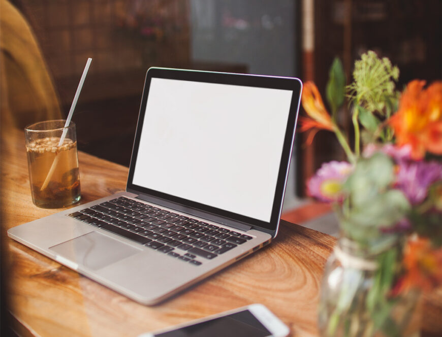 MacBook Pro on a Café Table Mockup Generator - Mockup World