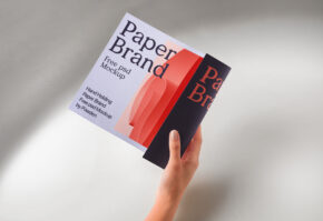 Hand holding Flyer Mockup - Mockup World